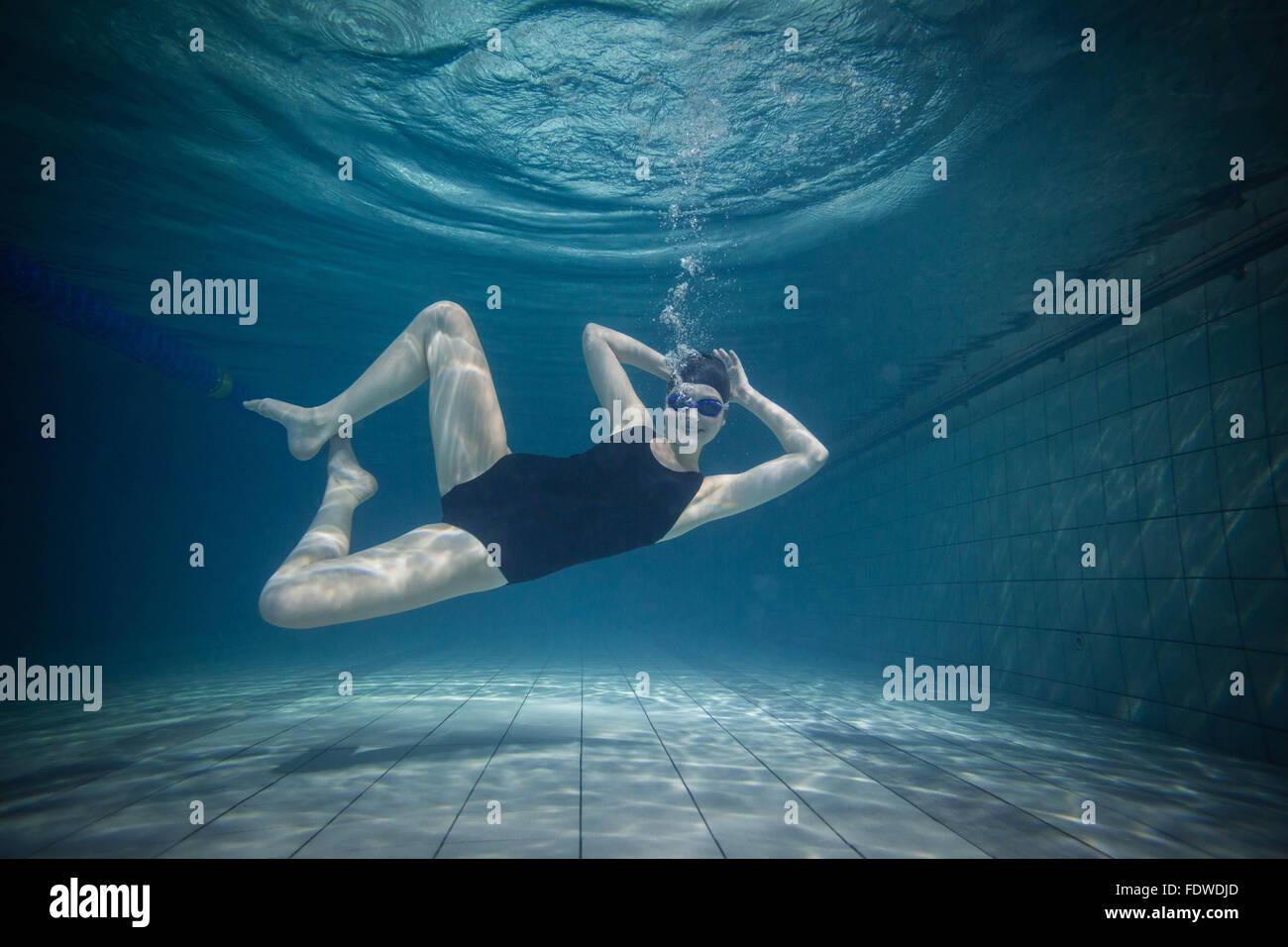 Pretty woman stretching underwater Stock Photo - Alamy