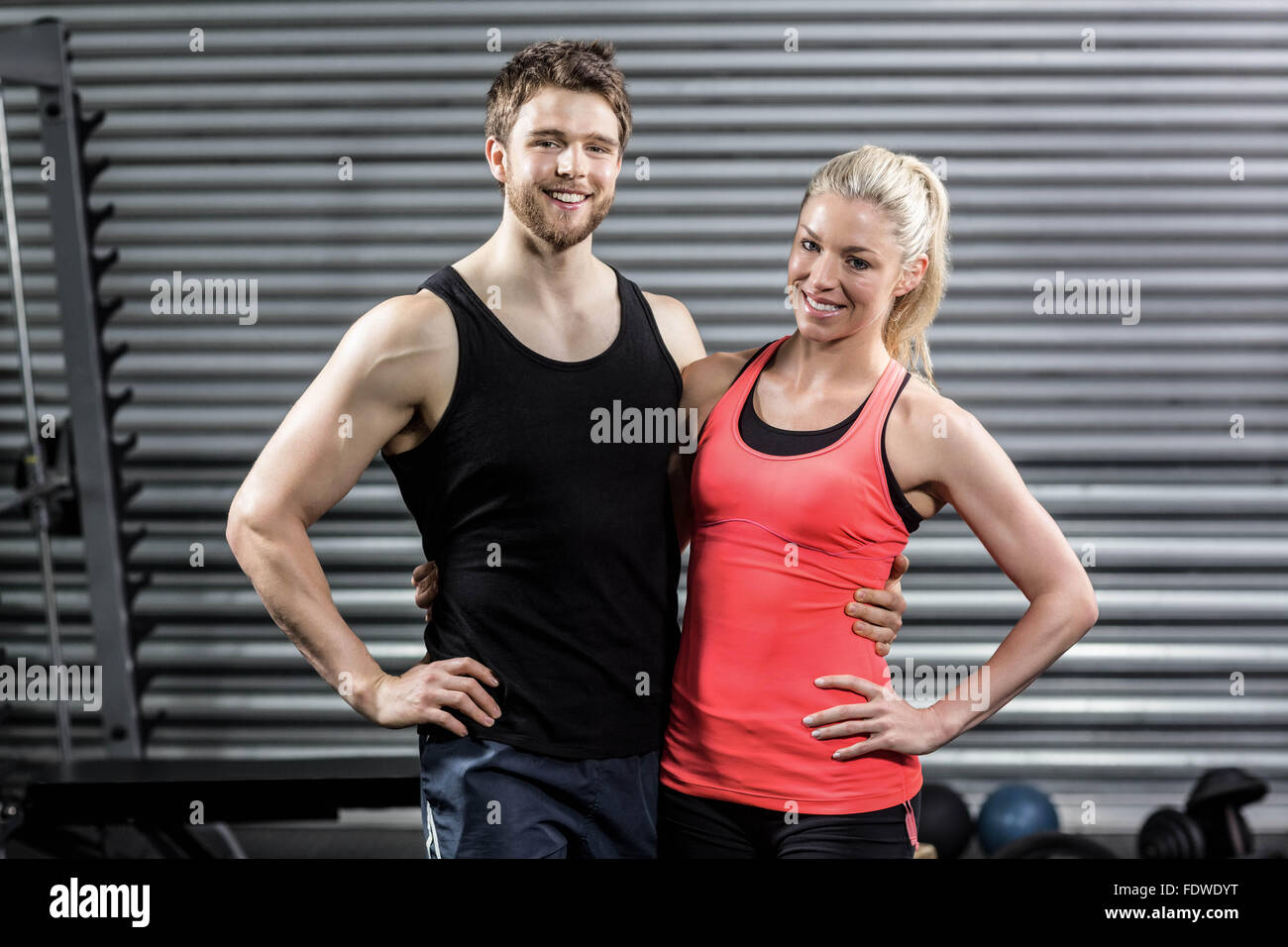Happy fit couple embracing Stock Photo - Alamy
