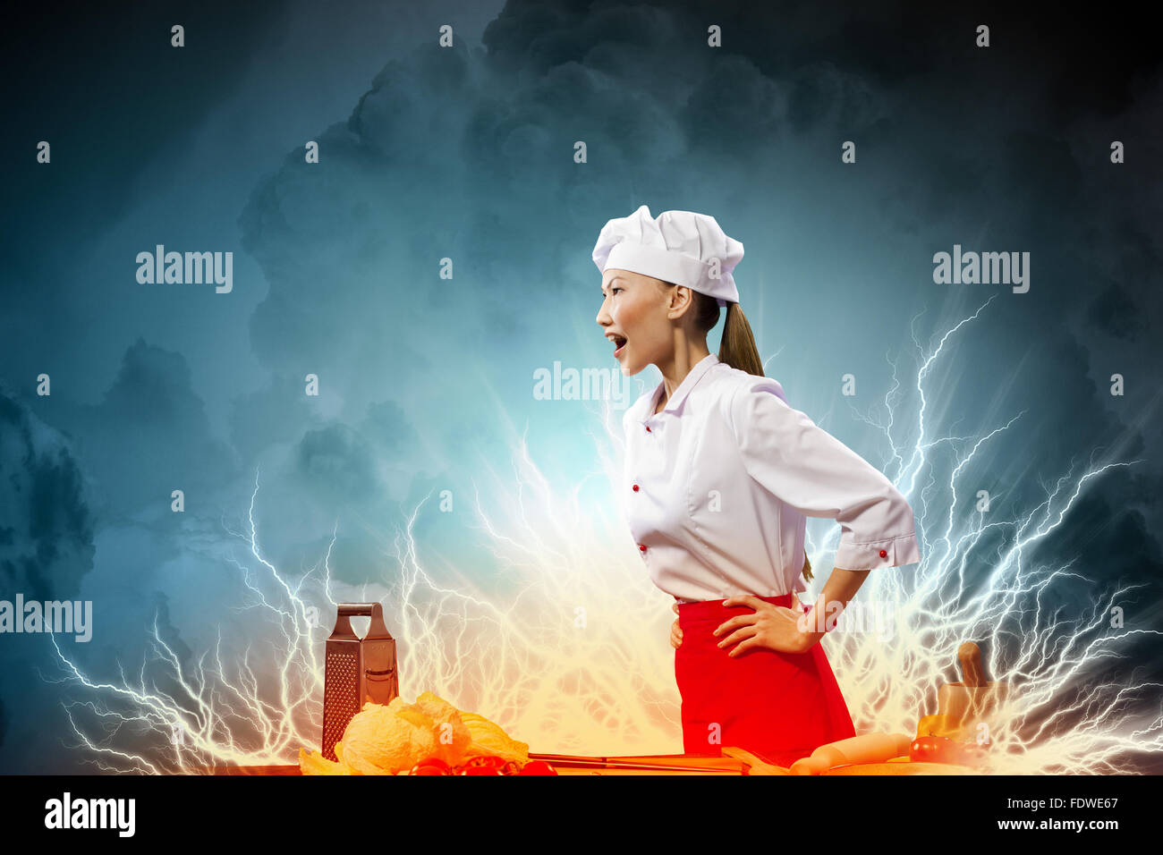 Asian female cook in anger against color background with shine effects ...