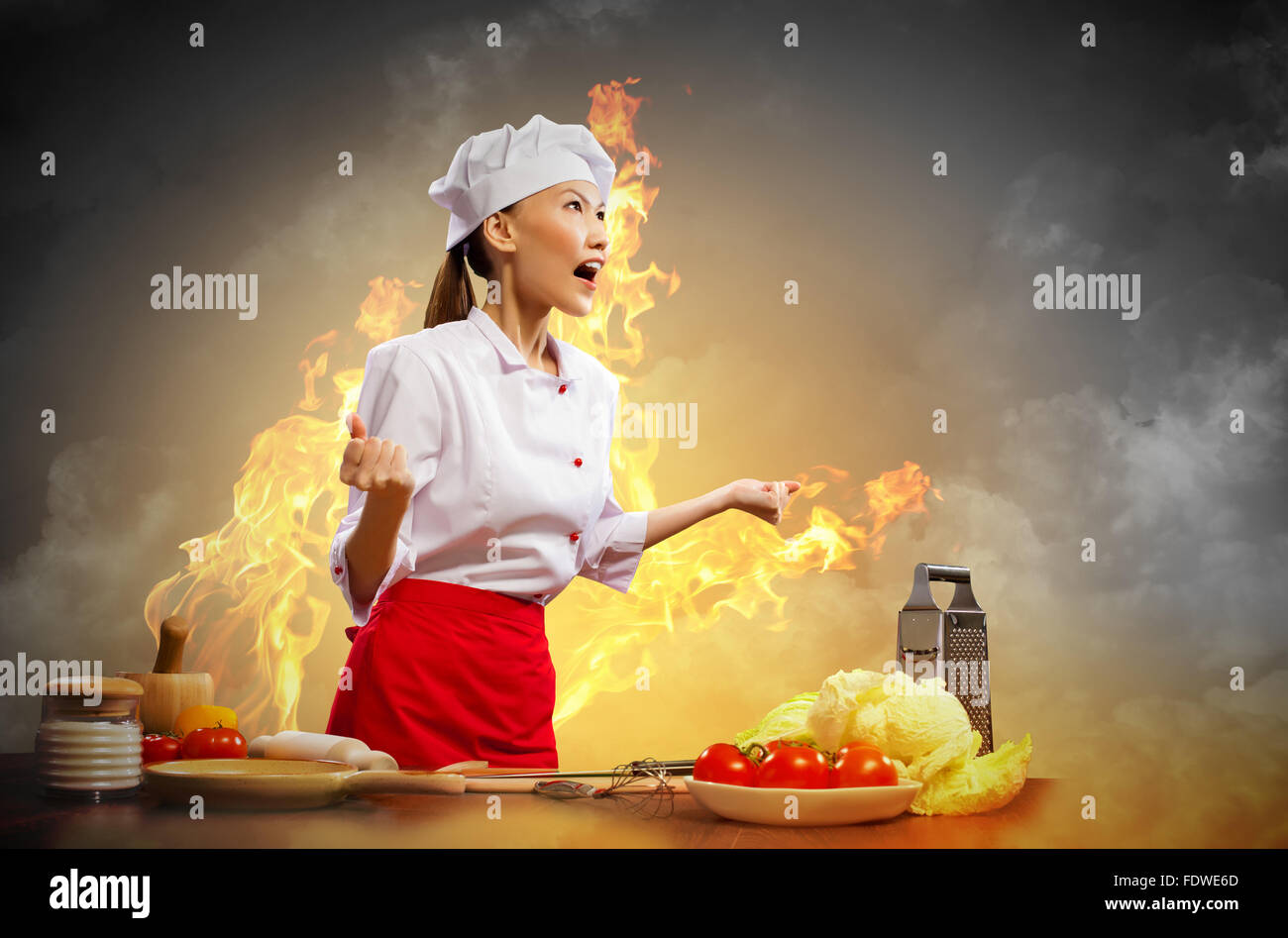 Asian female cook in anger against color background with shine effects ...
