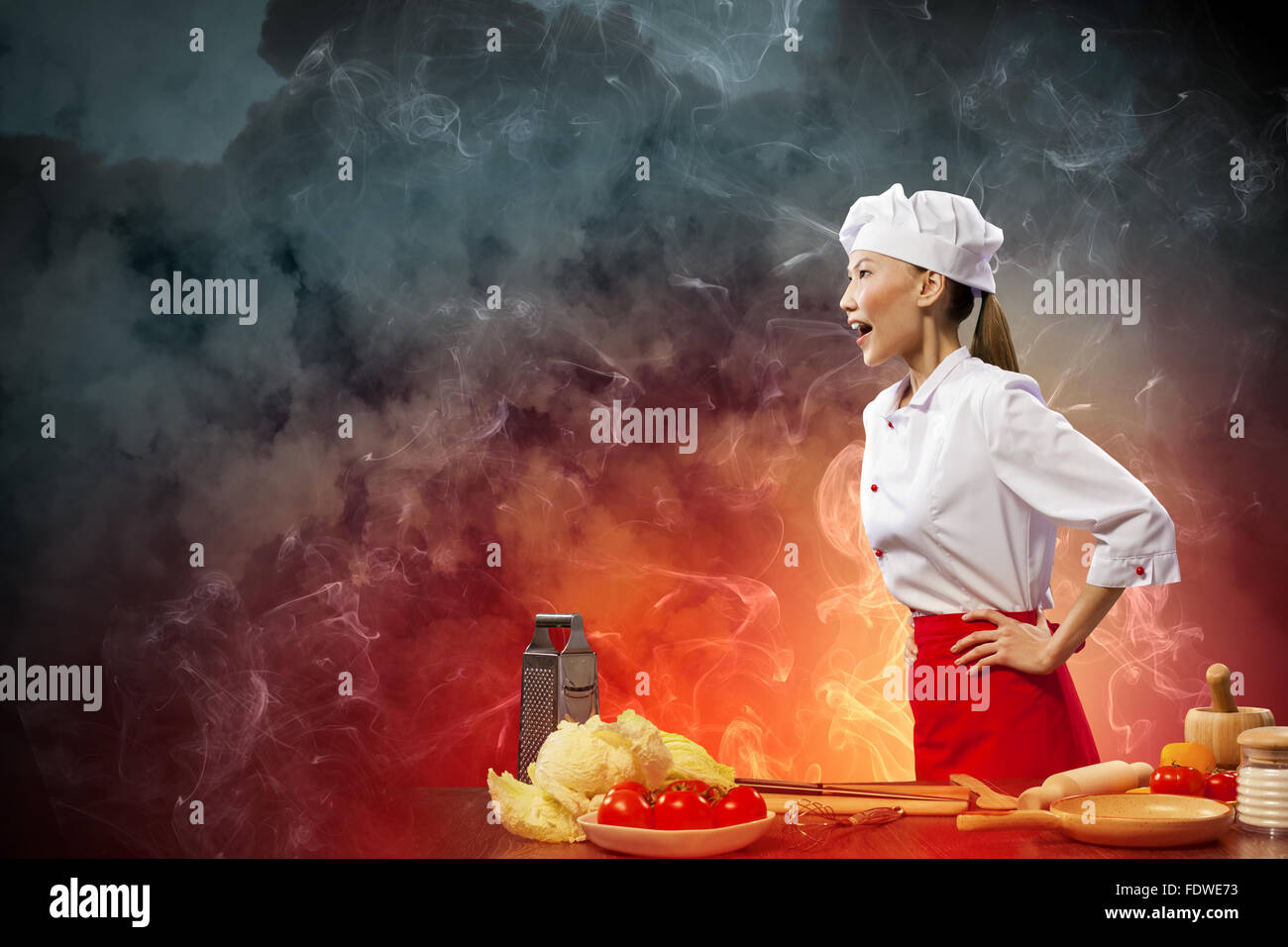 Asian female cook in anger against color background with shine effects ...