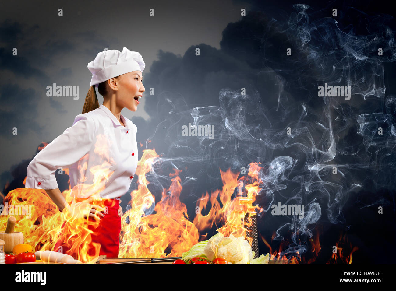 Asian female cook in anger against color background with shine effects ...