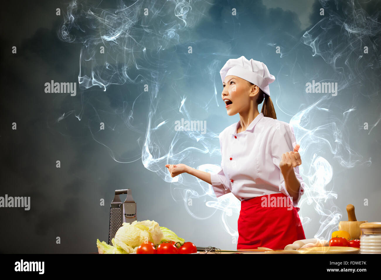 Asian female cook in anger against color background with shine effects ...
