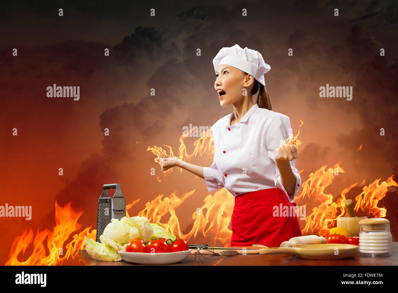 Asian female cook in anger against color background with shine effects ...