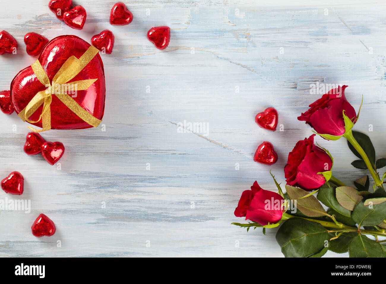 Red roses and heart shaped chocolate candies Stock Photo - Alamy