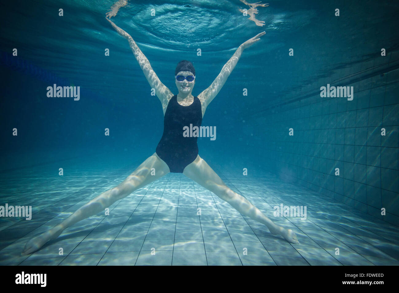 Pretty woman stretching underwater Stock Photo - Alamy