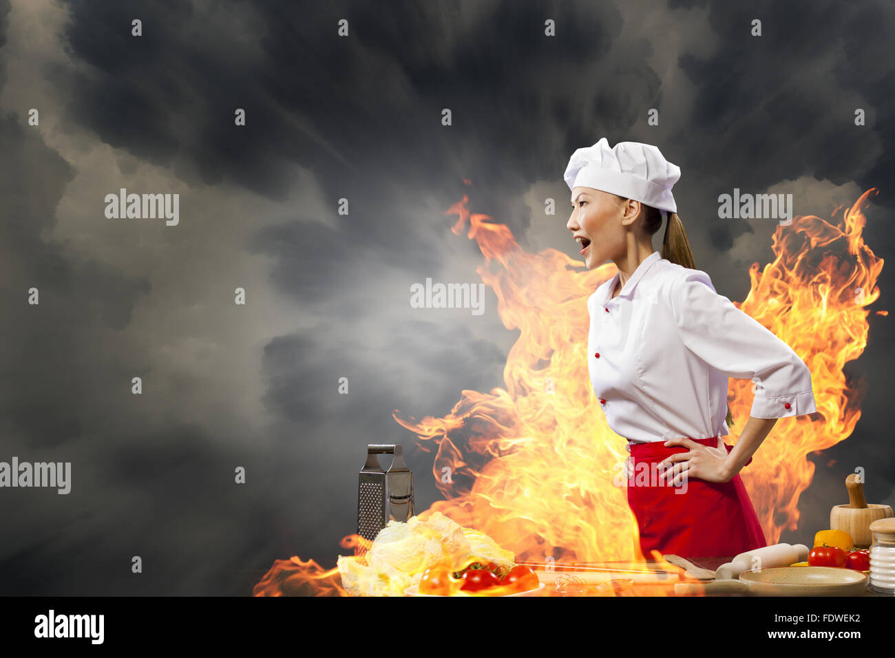 Asian female cook in anger against color background with shine effects ...