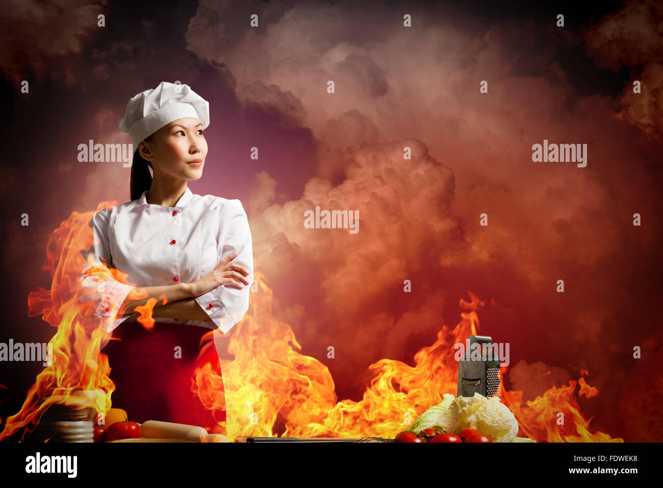 Asian female cook in anger against color background with shine effects ...