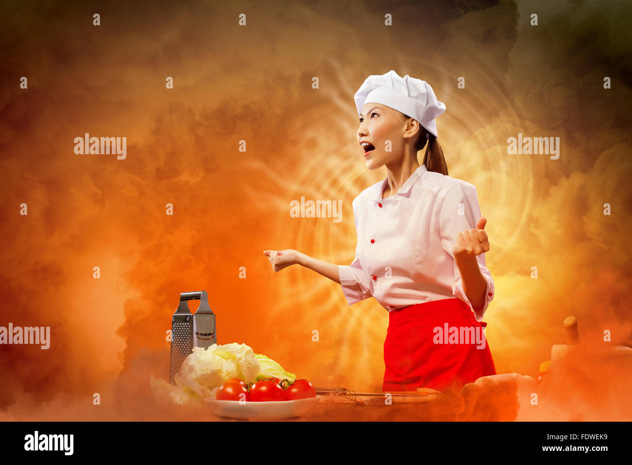 Asian female cook in anger against color background with shine effects ...