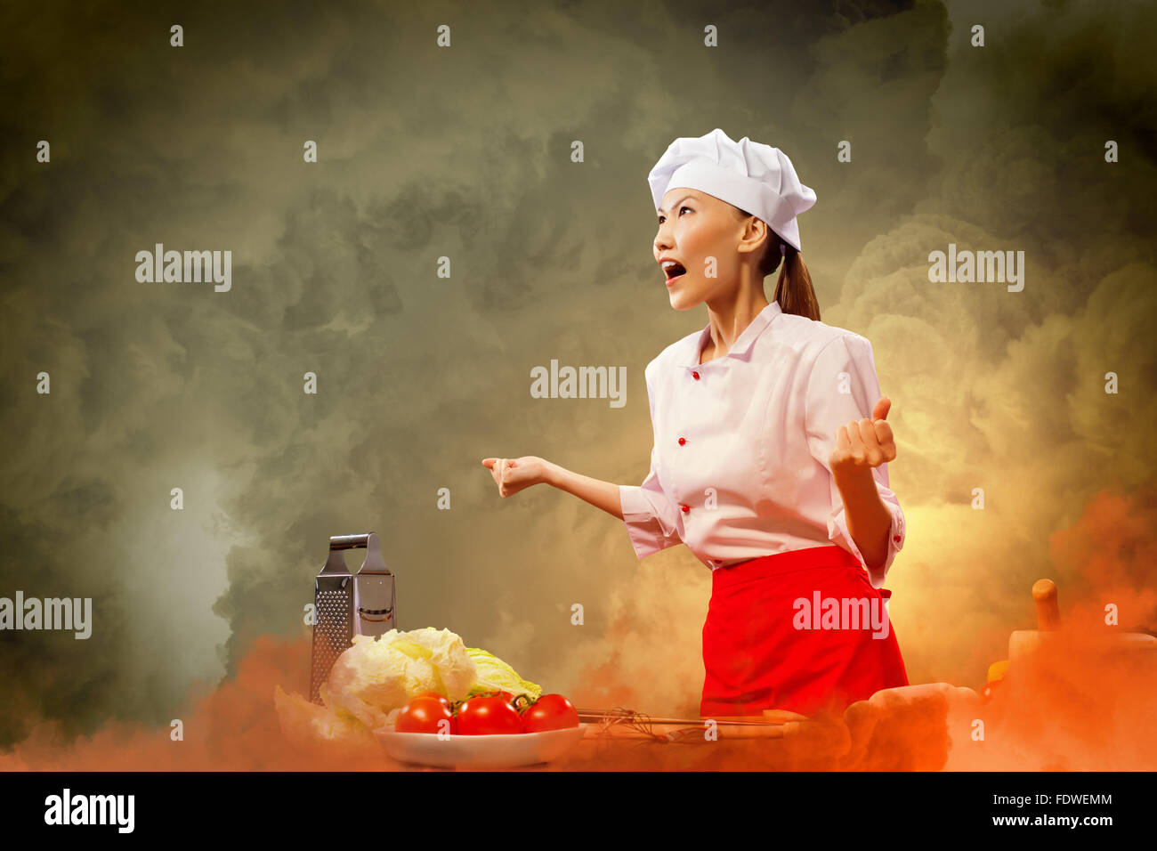 Asian female cook in anger against color background with shine effects ...