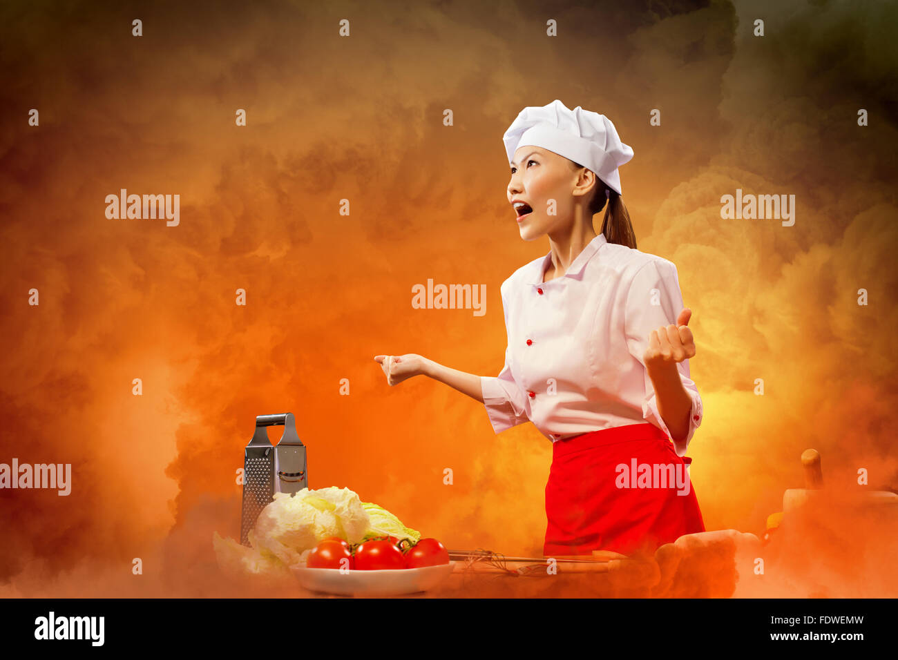 Asian female cook in anger against color background with shine effects ...