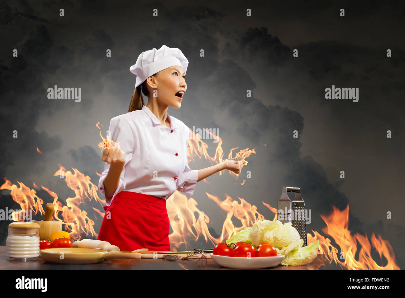 Asian female cook in anger against color background with shine effects ...