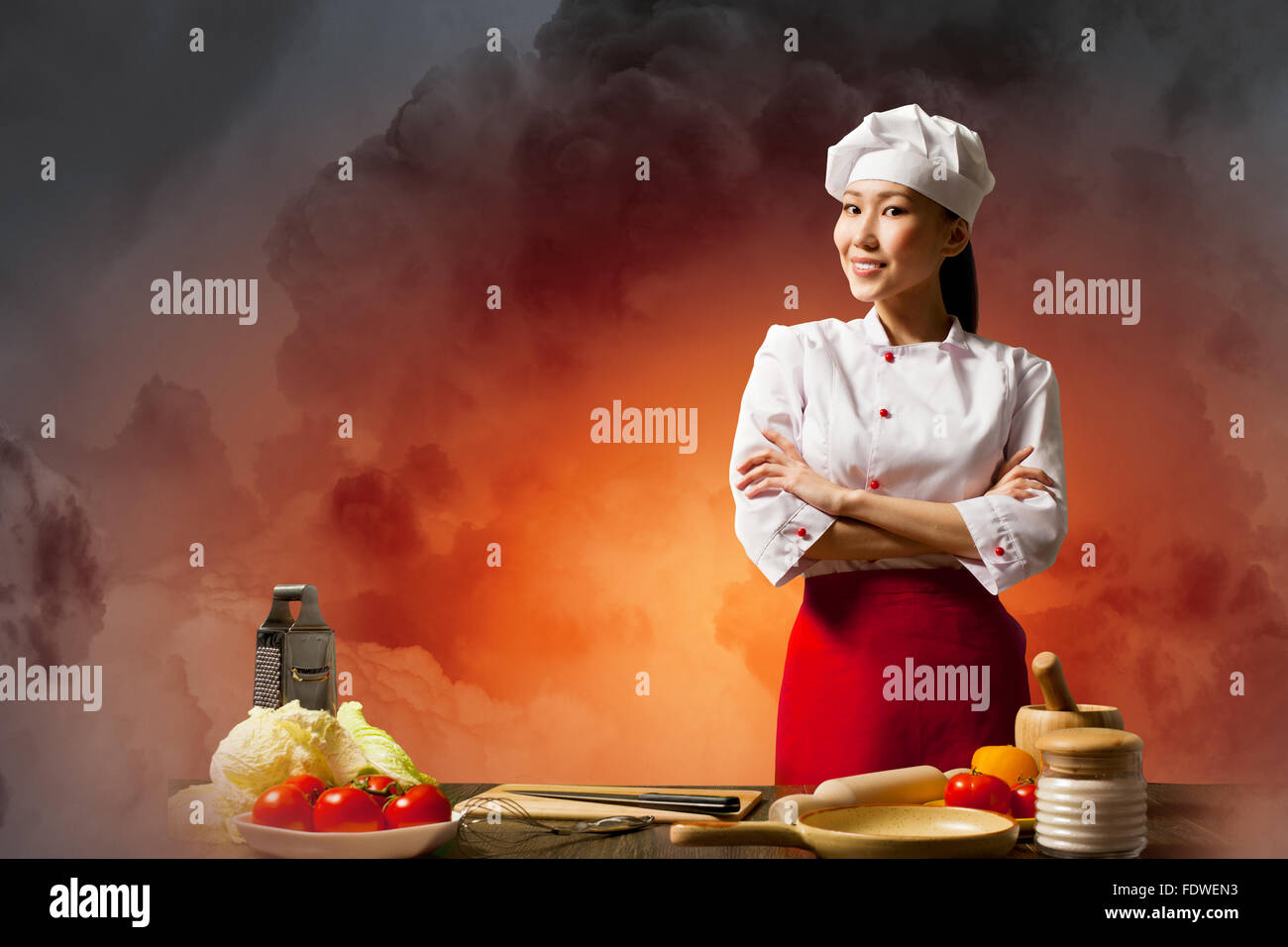Asian female cook in anger against color background with shine effects ...