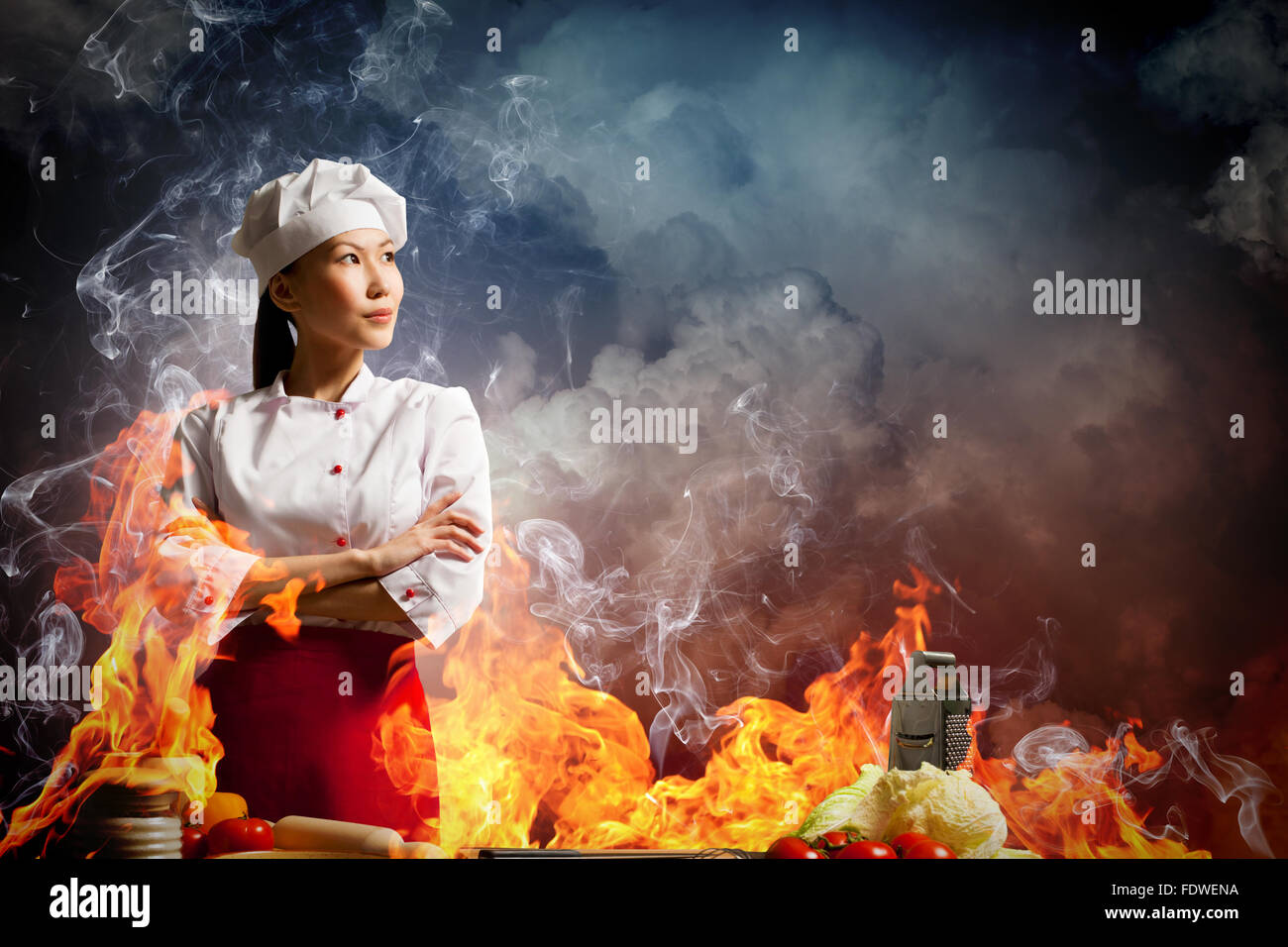 Asian female cook in anger against color background with shine effects ...