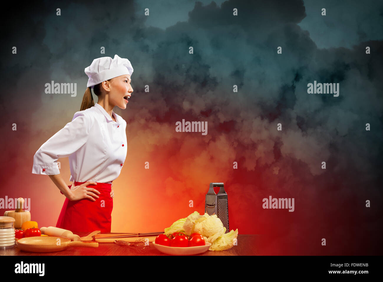Asian female cook in anger against color background with shine effects ...