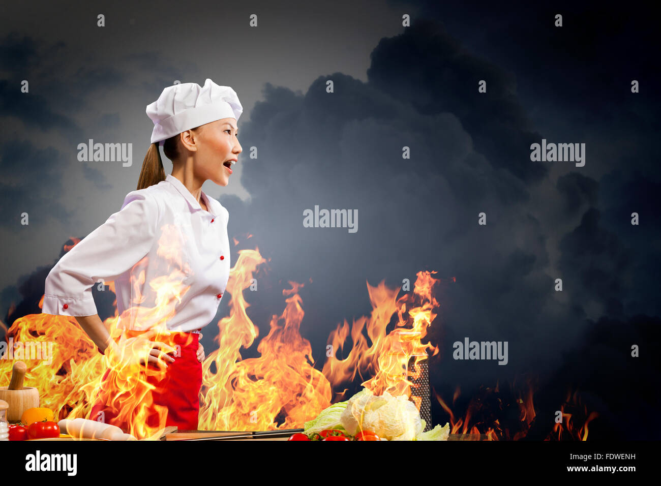 Asian female cook in anger against color background with shine effects ...