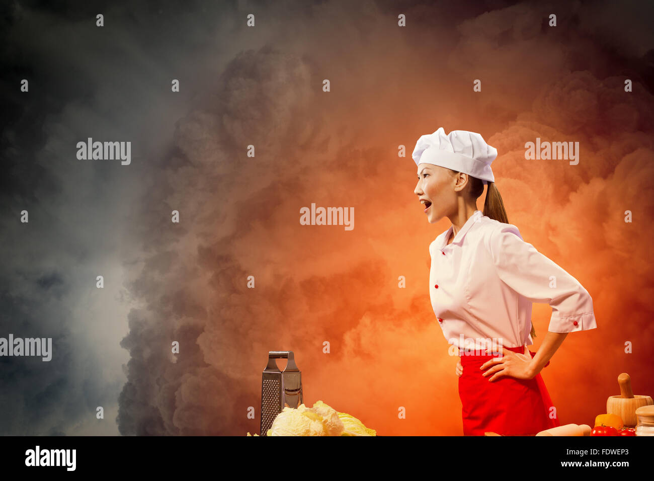 Asian female cook in anger against color background with shine effects ...