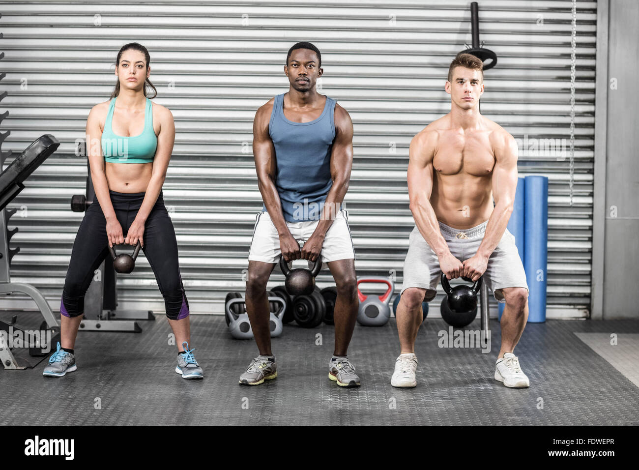 Fit people lifting dumbbells Stock Photo - Alamy