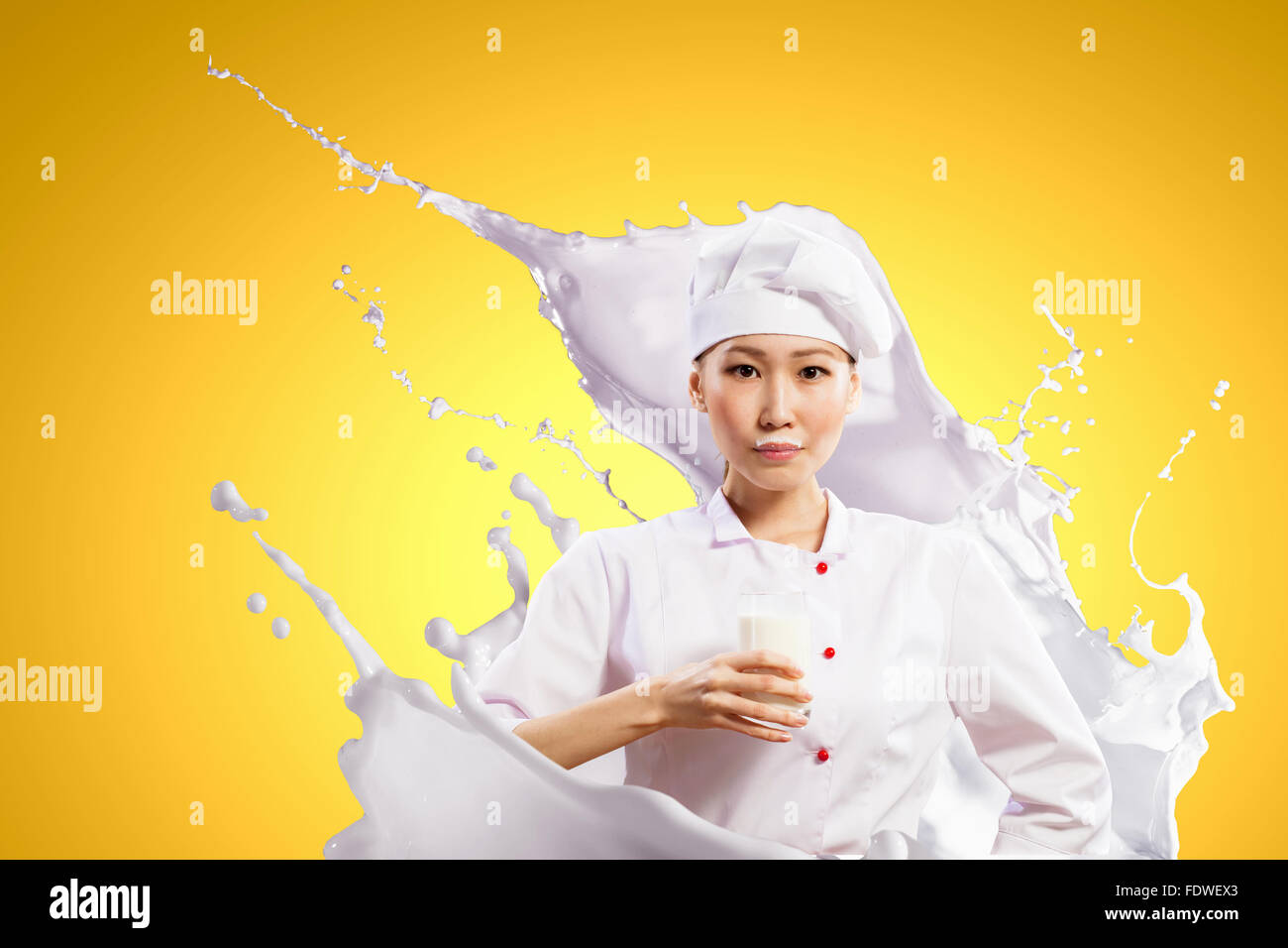 Asian female cook against milk splashes in red apron against color ...