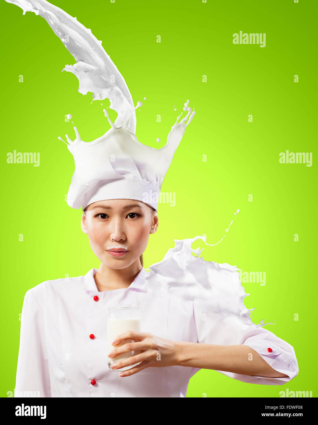 Asian female cook against milk splashes in red apron against color ...
