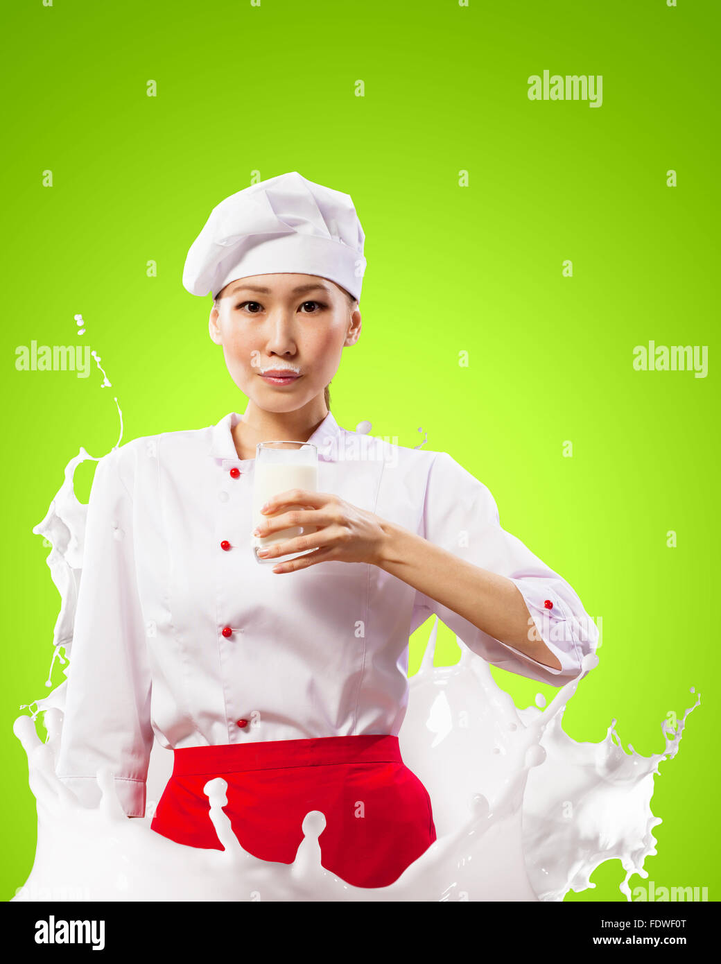 Asian female cook against milk splashes in red apron against color ...