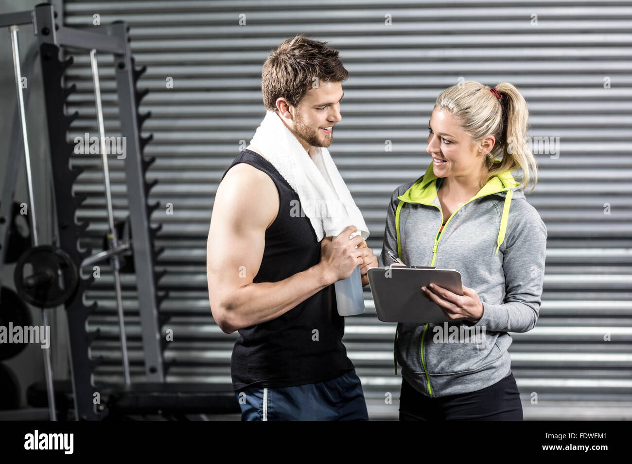 Smiling fit couple taking notes Stock Photo - Alamy