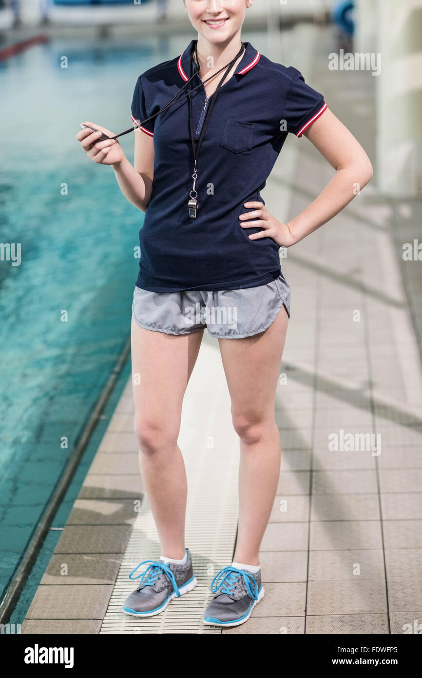 Pretty trainer holding a stopwatch Stock Photo - Alamy