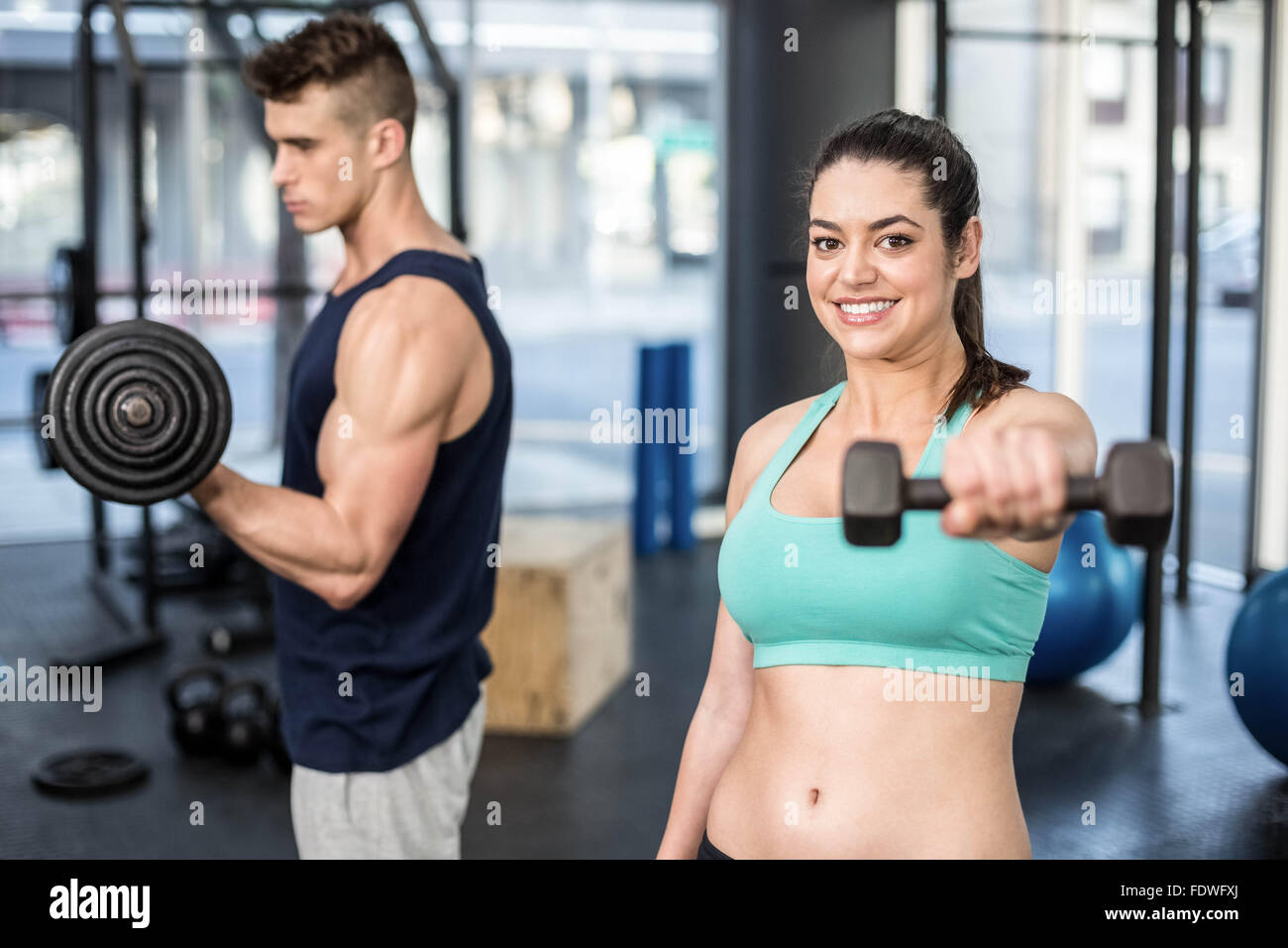 Fit people lifting dumbbells Stock Photo - Alamy