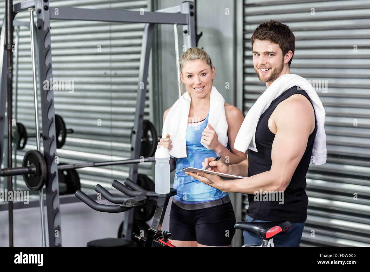 Smiling fit couple taking notes Stock Photo - Alamy