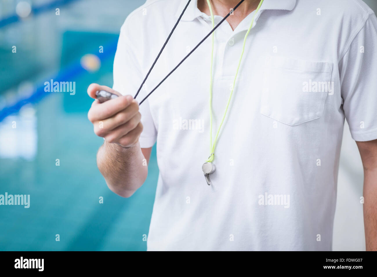 Fit trainer looking at stopwatch Stock Photo - Alamy
