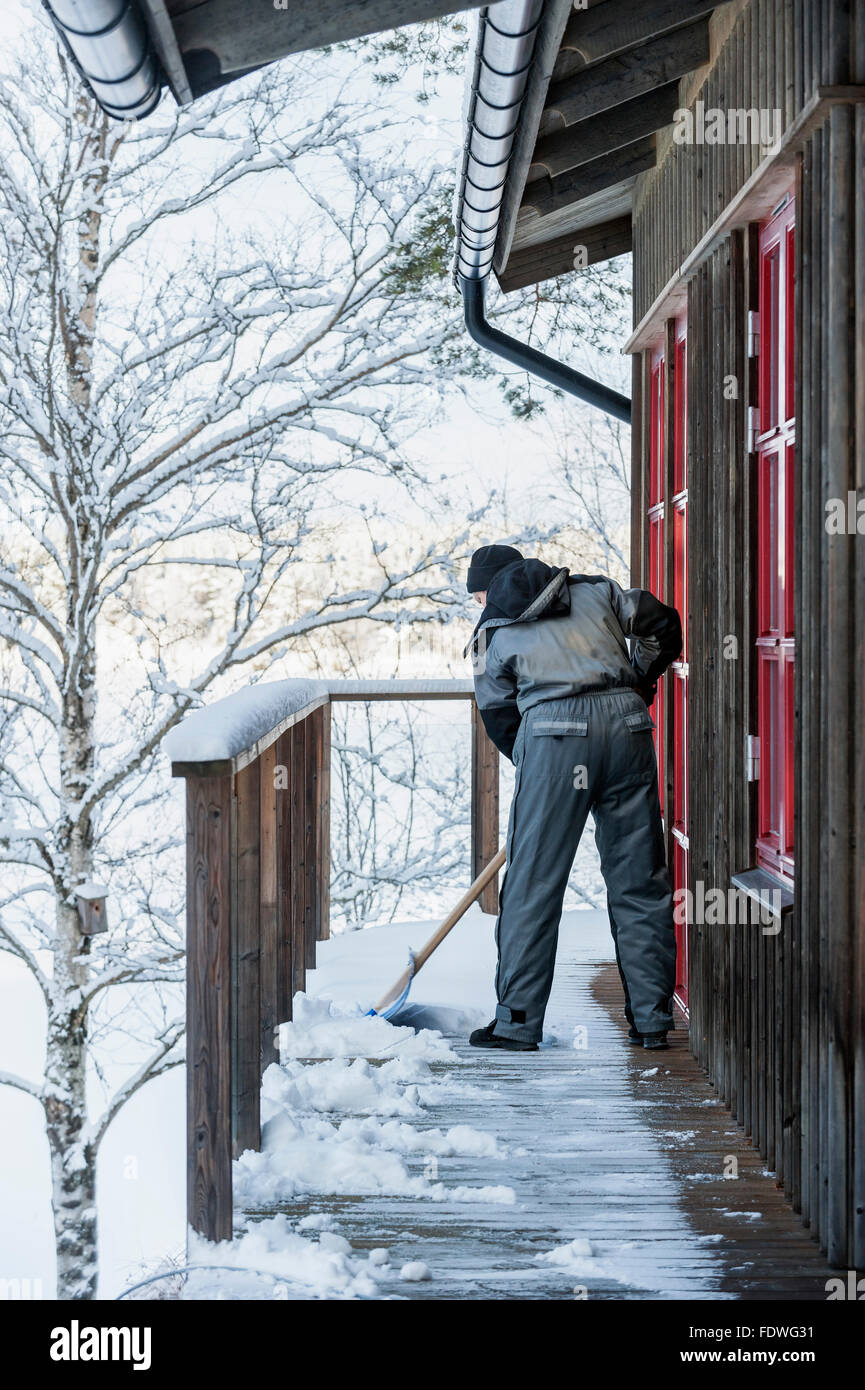 Clearing a terrace from snow, Sweden Stock Photo - Alamy