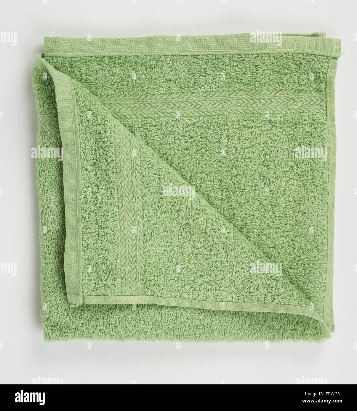 One green terry towel on white background Stock Photo - Alamy