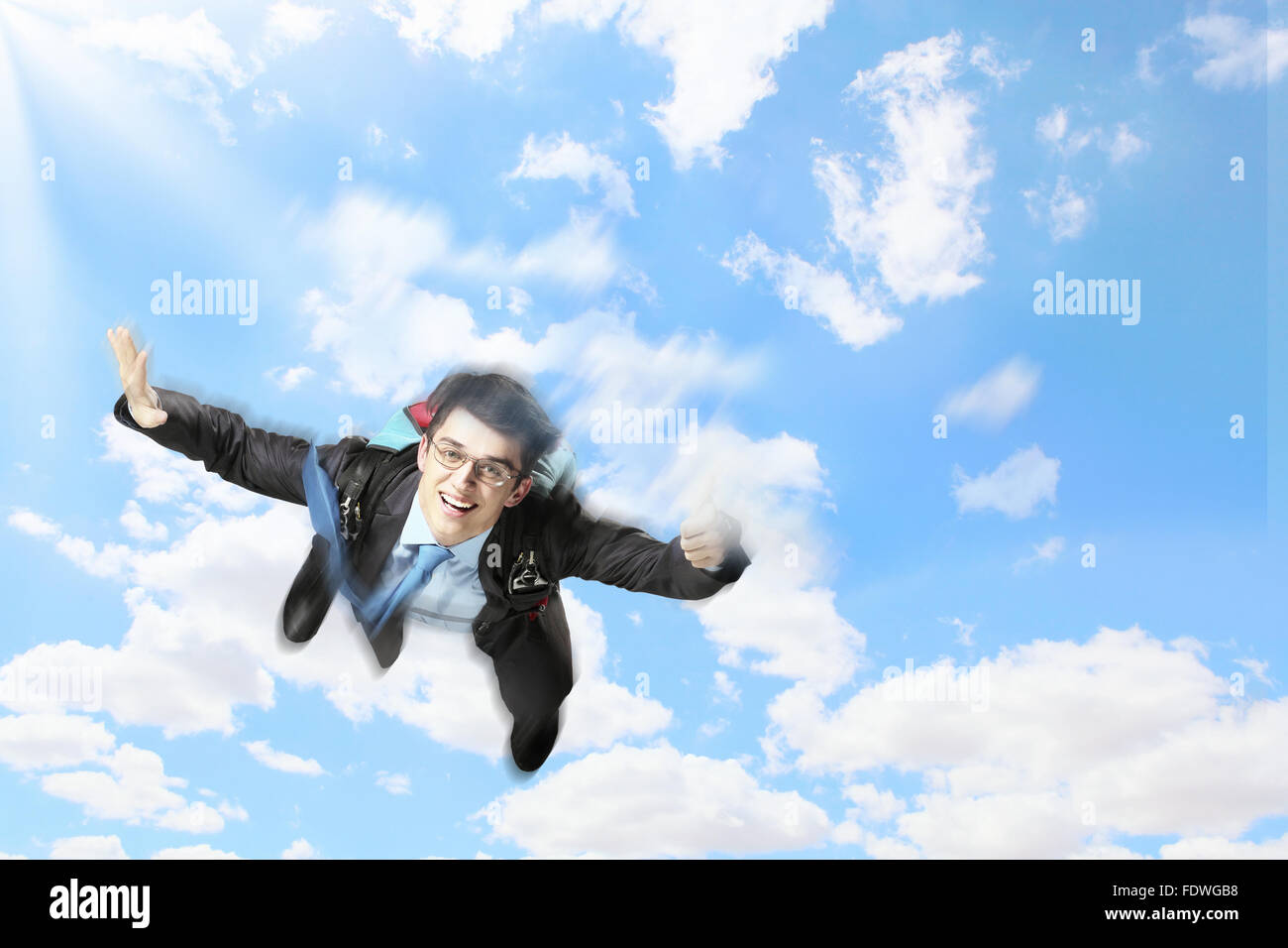 Conceptual image of young businessman flying with parachute on back ...