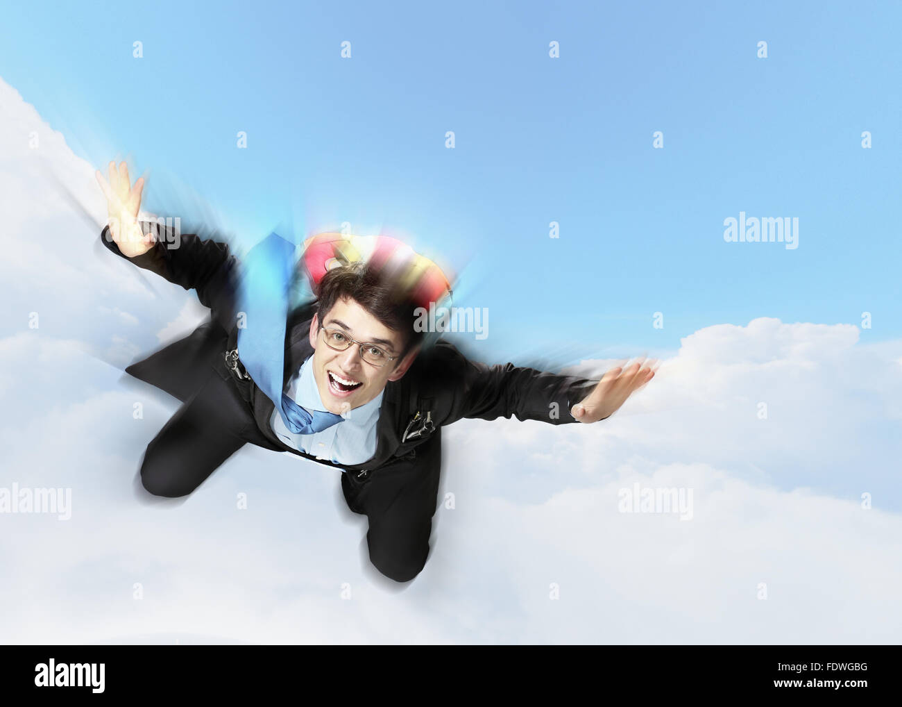 Conceptual image of young businessman flying with parachute on back ...