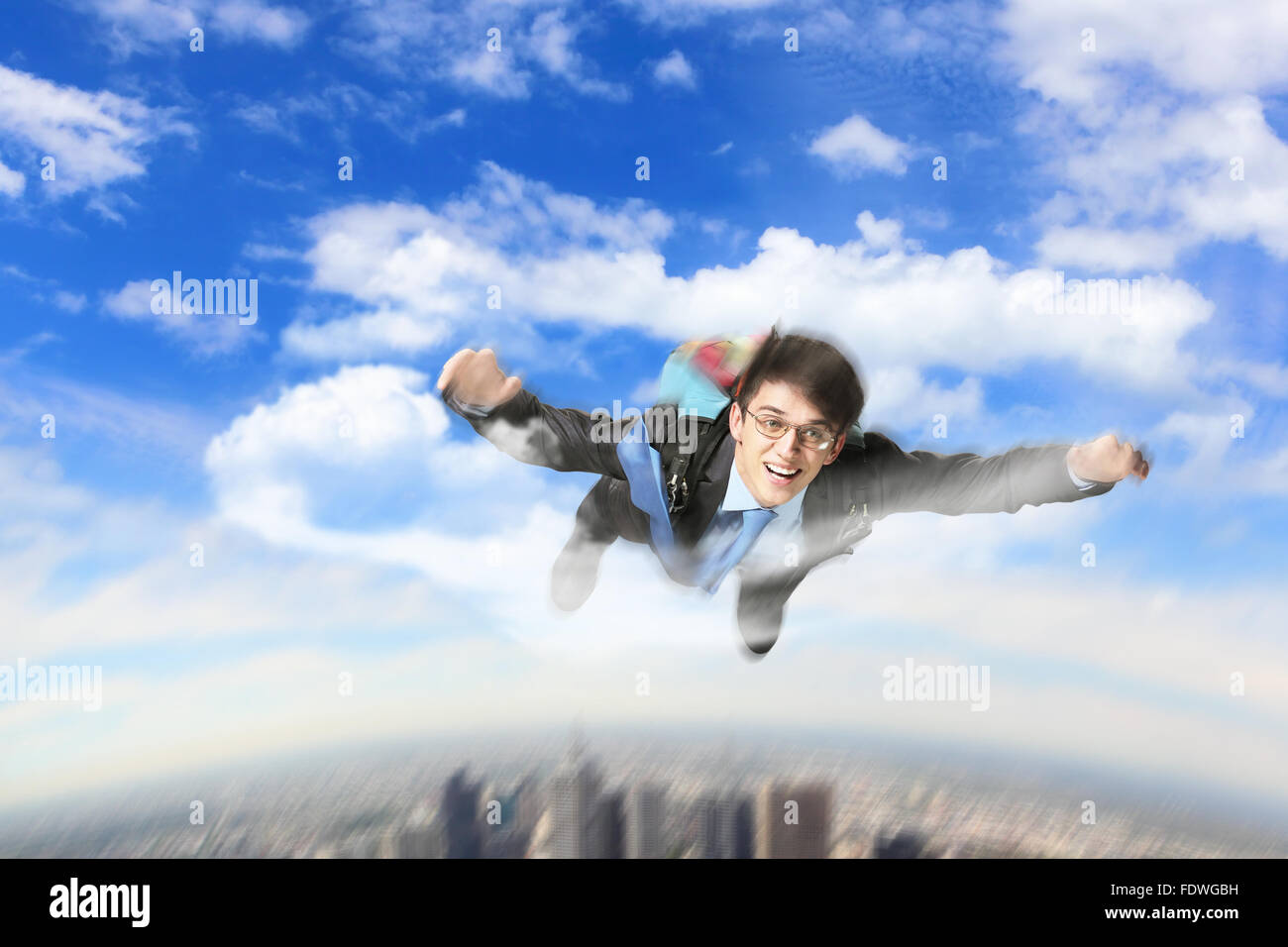 Conceptual image of young businessman flying with parachute on back ...