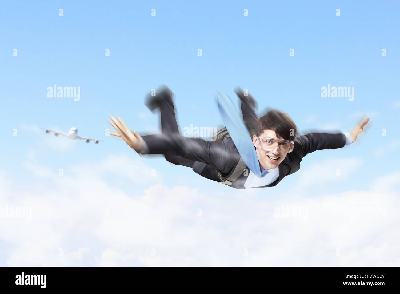Conceptual image of young businessman flying with parachute on back ...