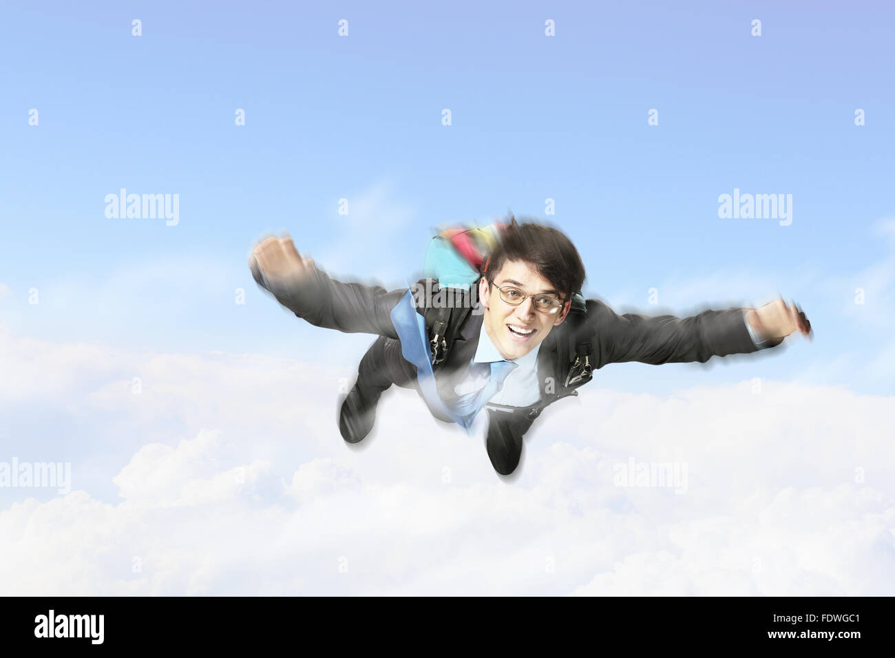 Conceptual image of young businessman flying with parachute on back ...
