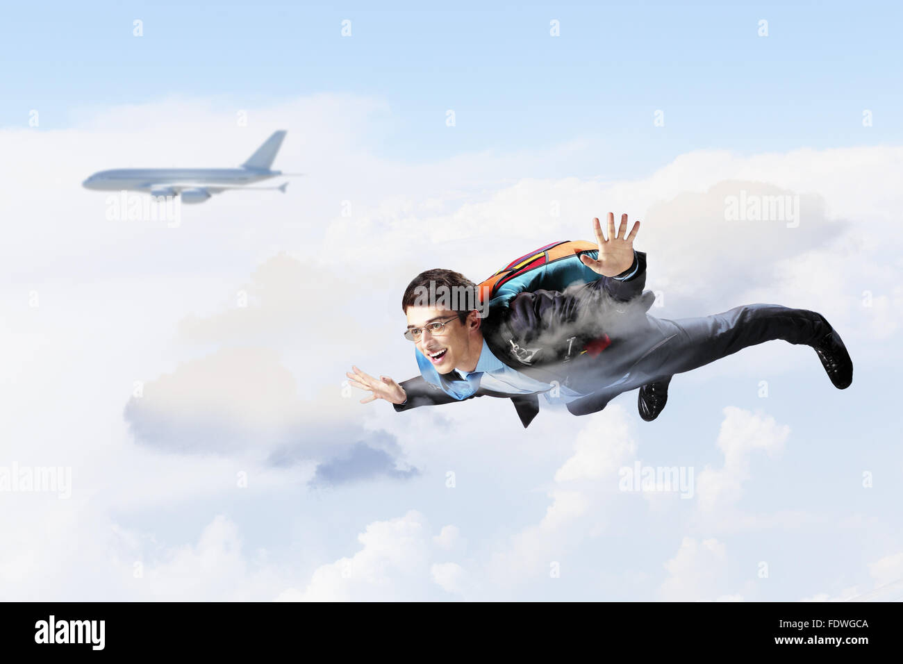 Conceptual image of young businessman flying with parachute on back ...