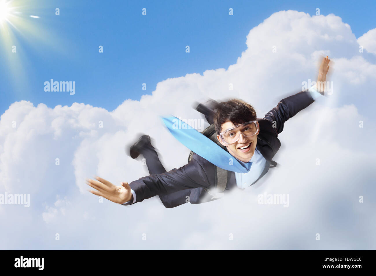 Conceptual image of young businessman flying with parachute on back ...