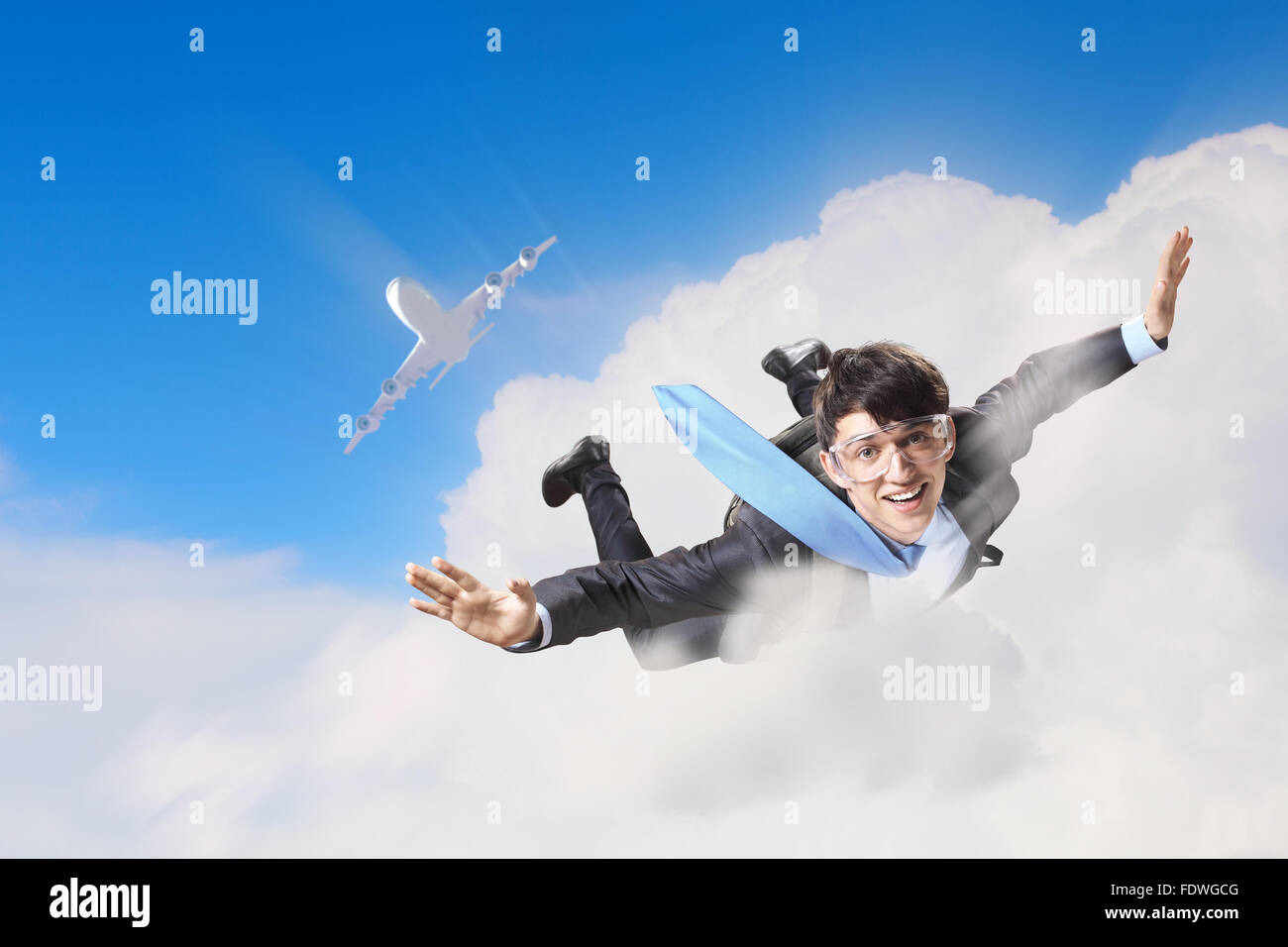 Conceptual image of young businessman flying with parachute on back ...