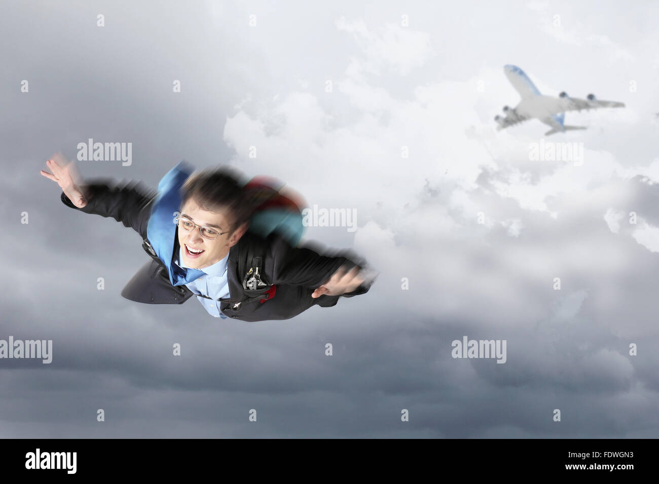Conceptual image of young businessman flying with parachute on back ...