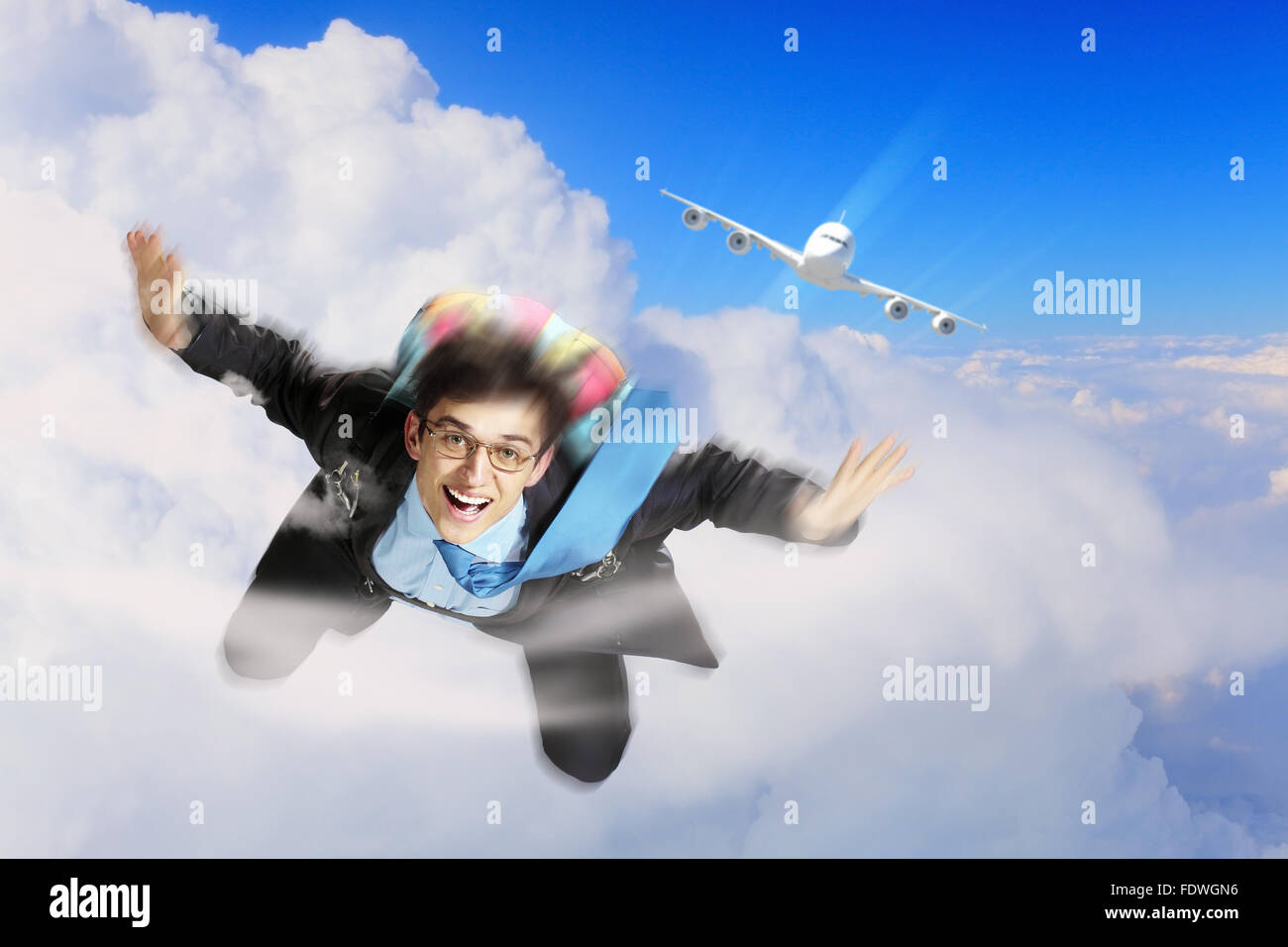Conceptual image of young businessman flying with parachute on back ...