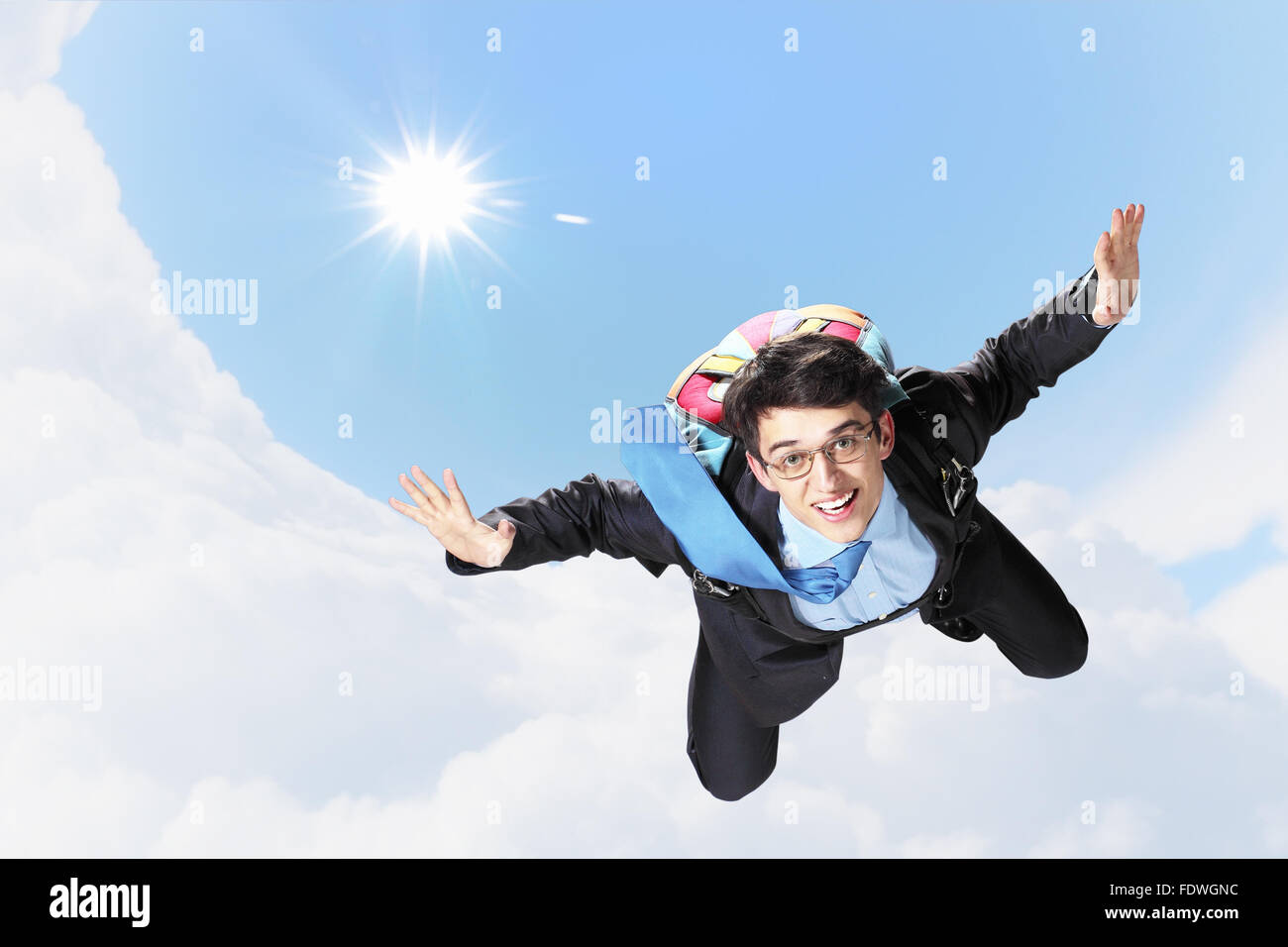 Conceptual image of young businessman flying with parachute on back ...