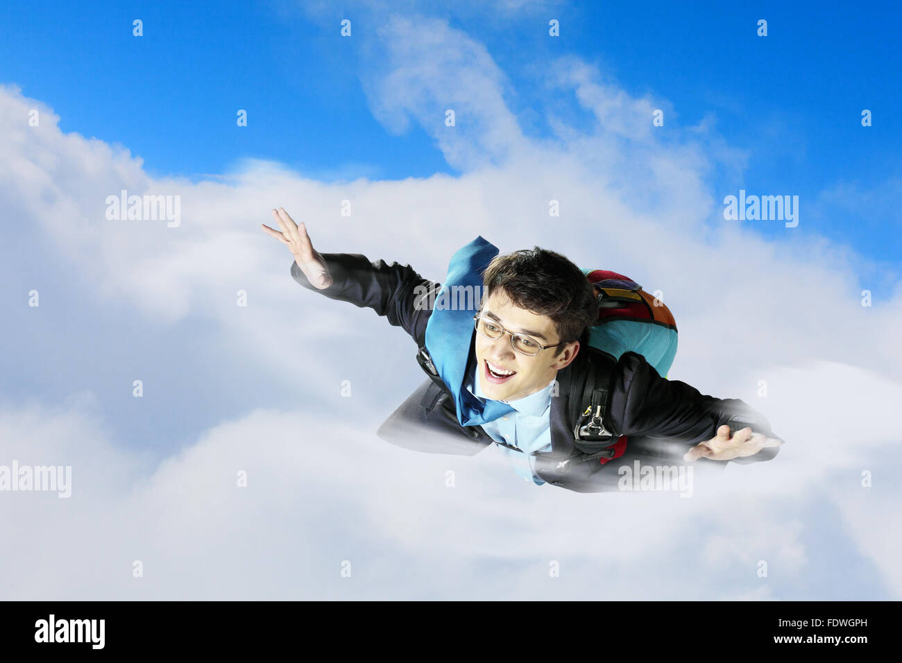 Conceptual image of young businessman flying with parachute on back ...