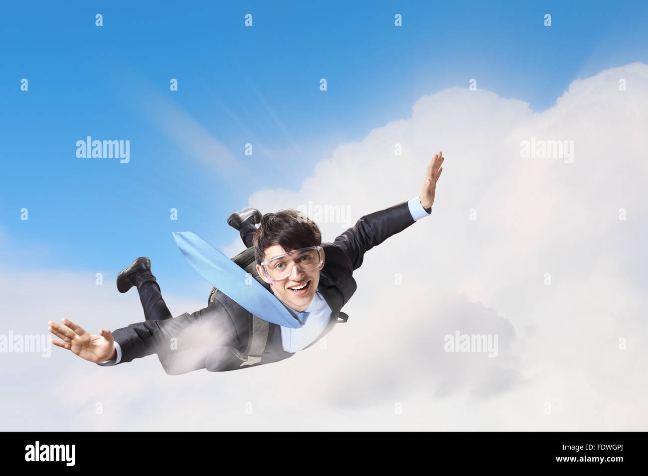Conceptual image of young businessman flying with parachute on back ...