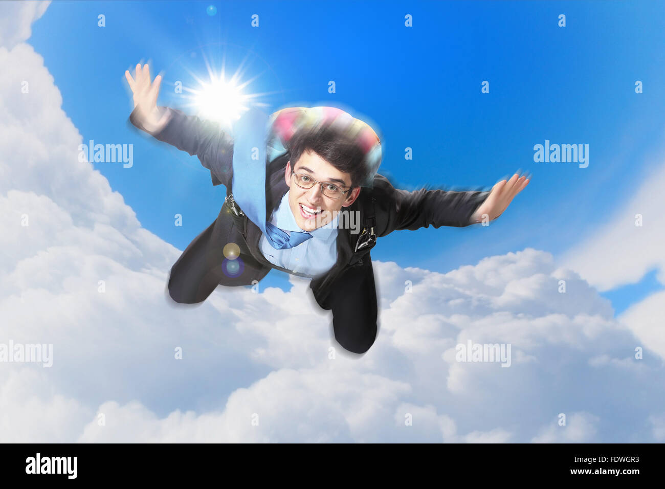 Conceptual image of young businessman flying with parachute on back ...