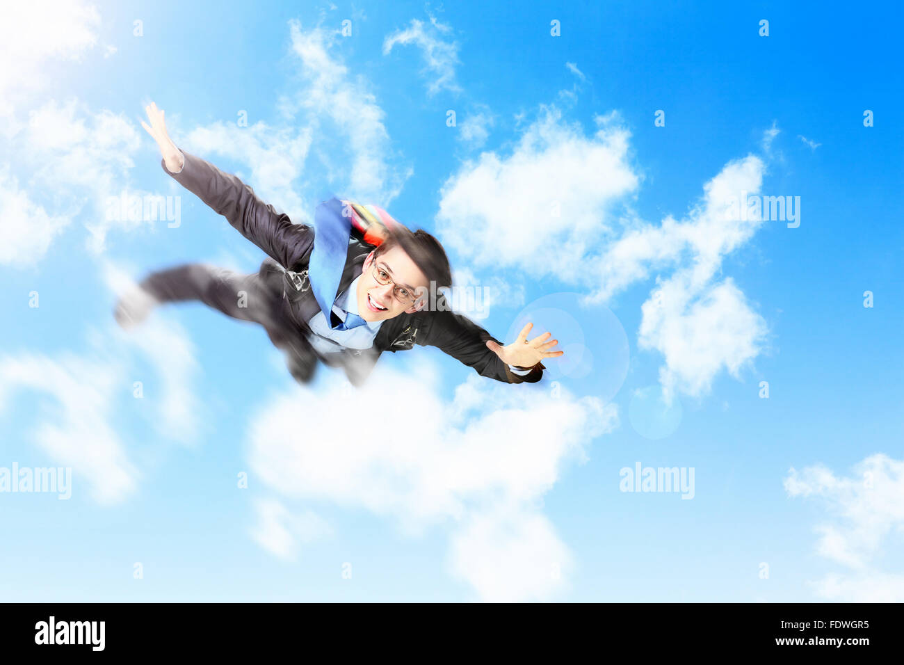 Conceptual image of young businessman flying with parachute on back ...