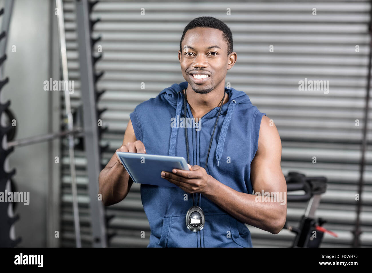 Athletic trainer using digital tablet Stock Photo - Alamy