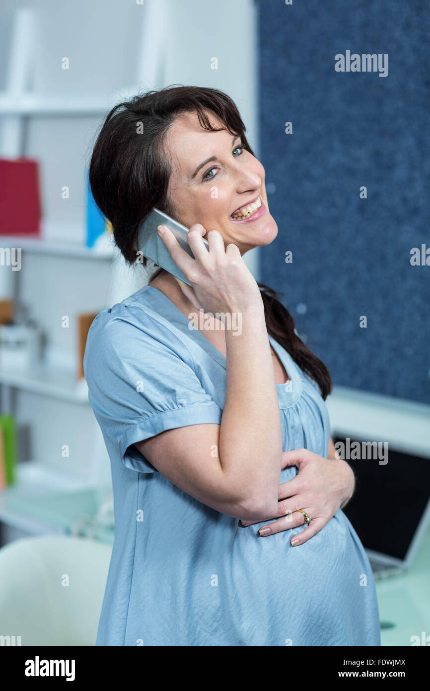 Pregnant woman on the phone Stock Photo - Alamy