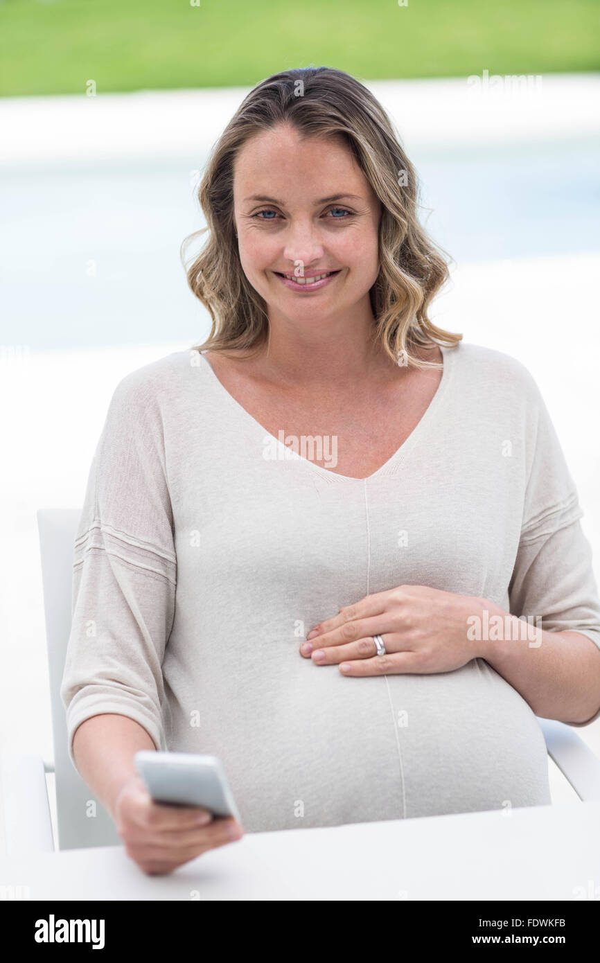 Pregnant woman texting Stock Photo - Alamy